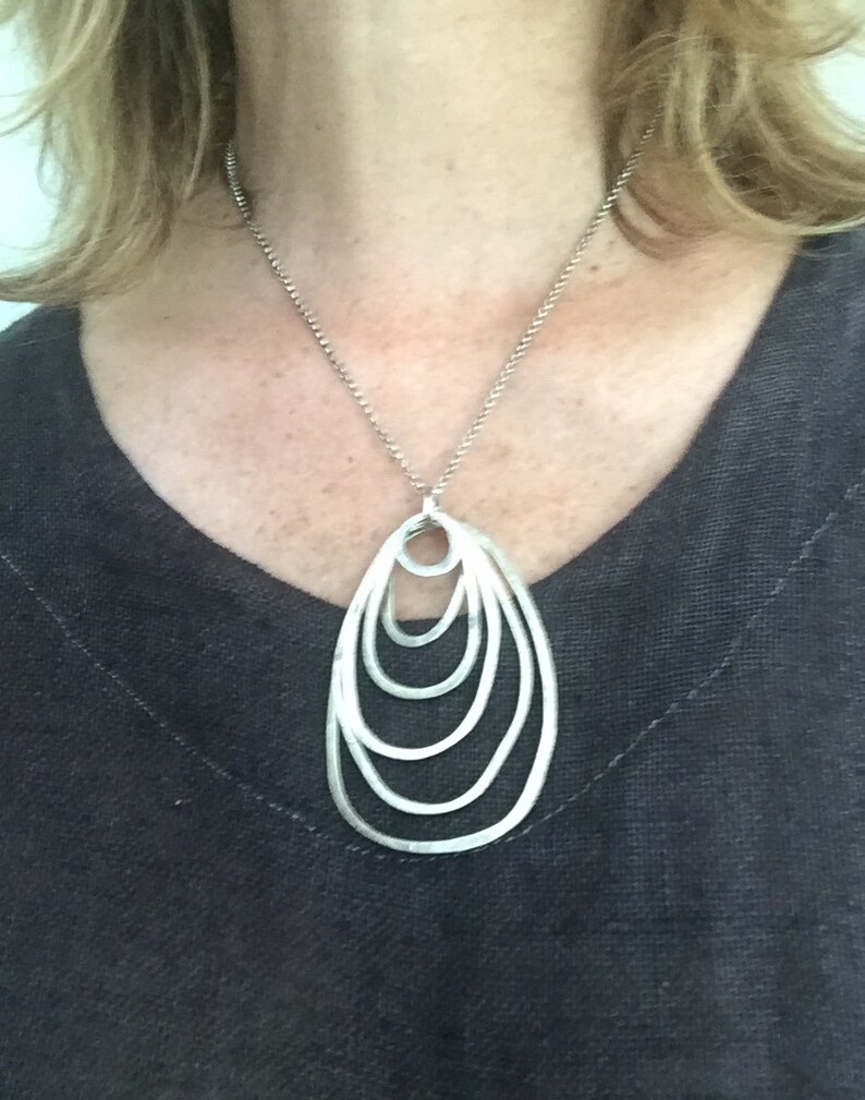 Sterling silver overlapping loops pendant on chain. | Etsy