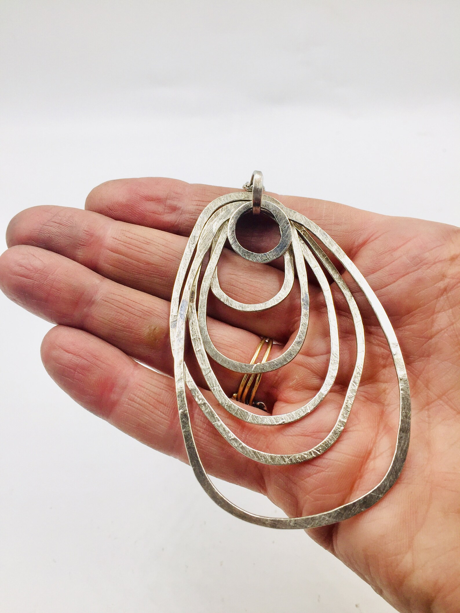 Sterling silver overlapping loops pendant on chain. | Etsy