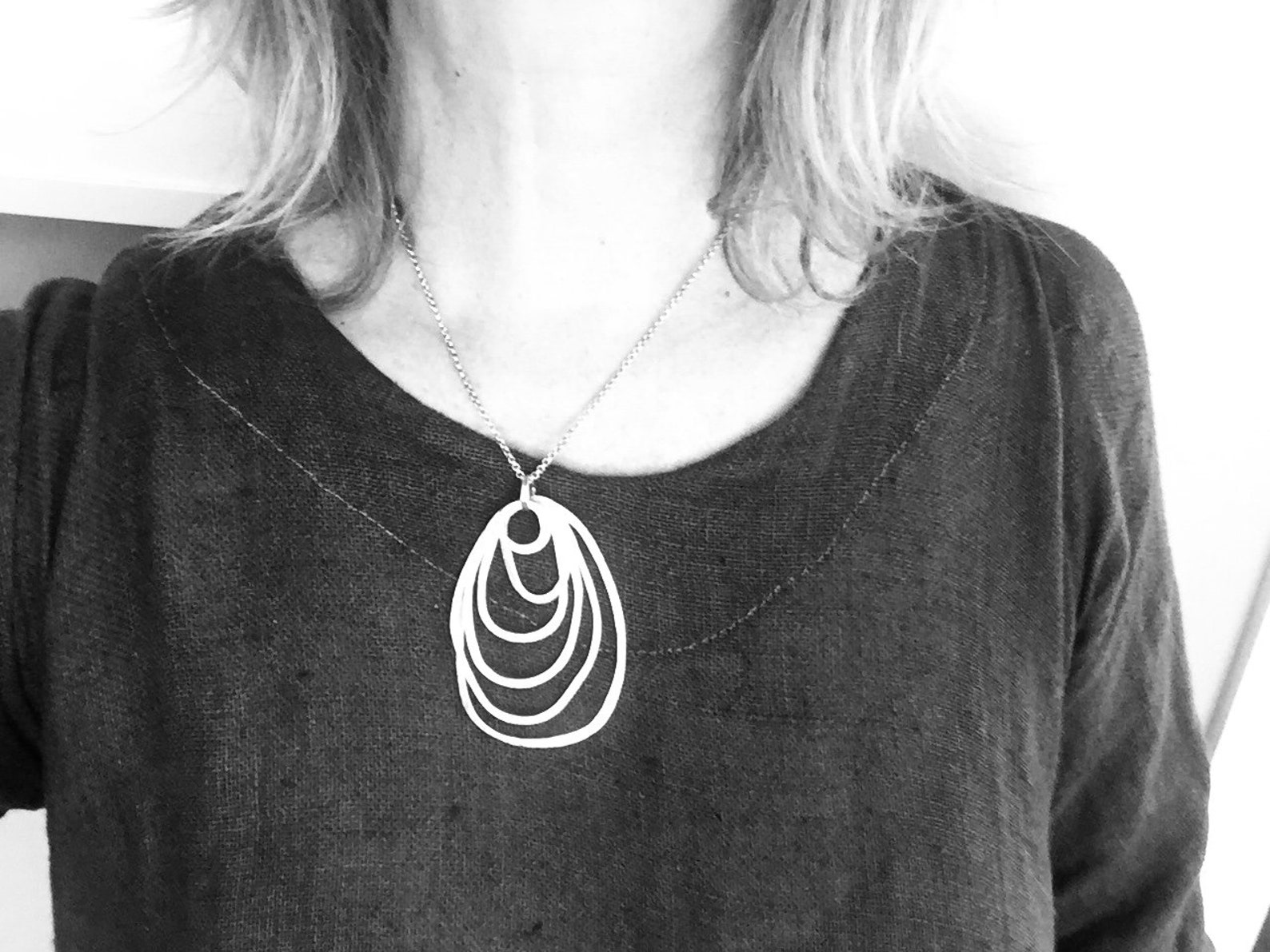 Sterling silver overlapping loops pendant on chain. | Etsy