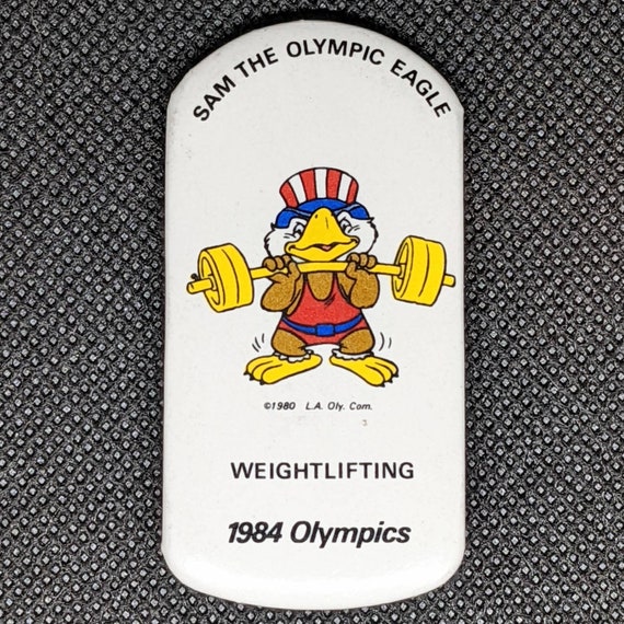 LA 1984 Olympics Sam The Eagle "Weightlifting" Pin/Bu… - Gem