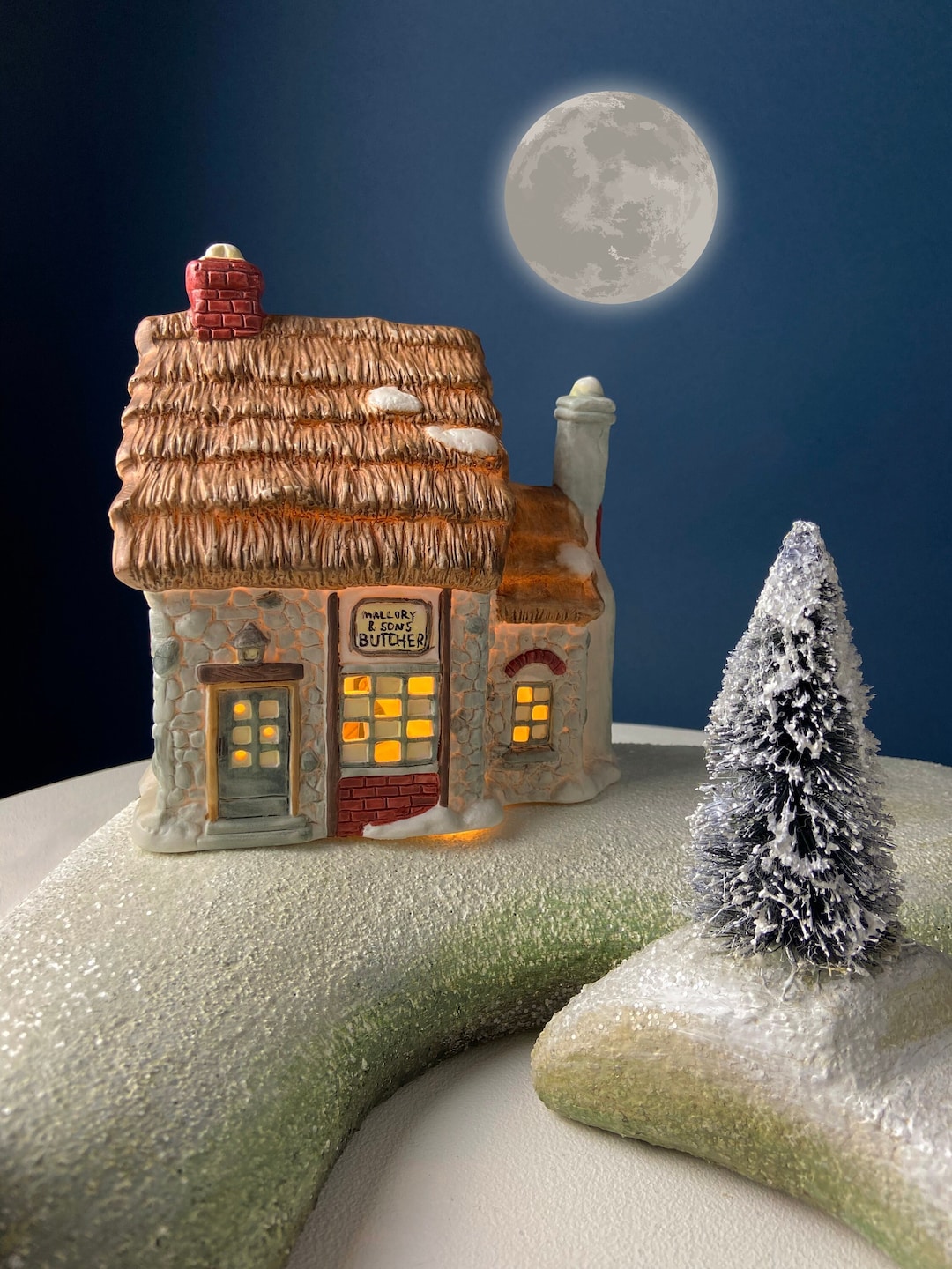 Mallory & Sons Butcher Shop With Thatched Roof. Illuminated Christmas ...