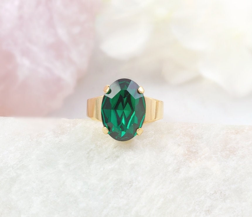 Gold ring with green stone store
