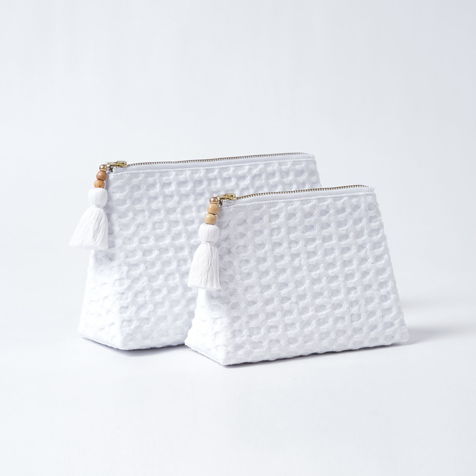 A Pair of White Waffle Nesting Pouches With Zipper Closure and Tassel ...