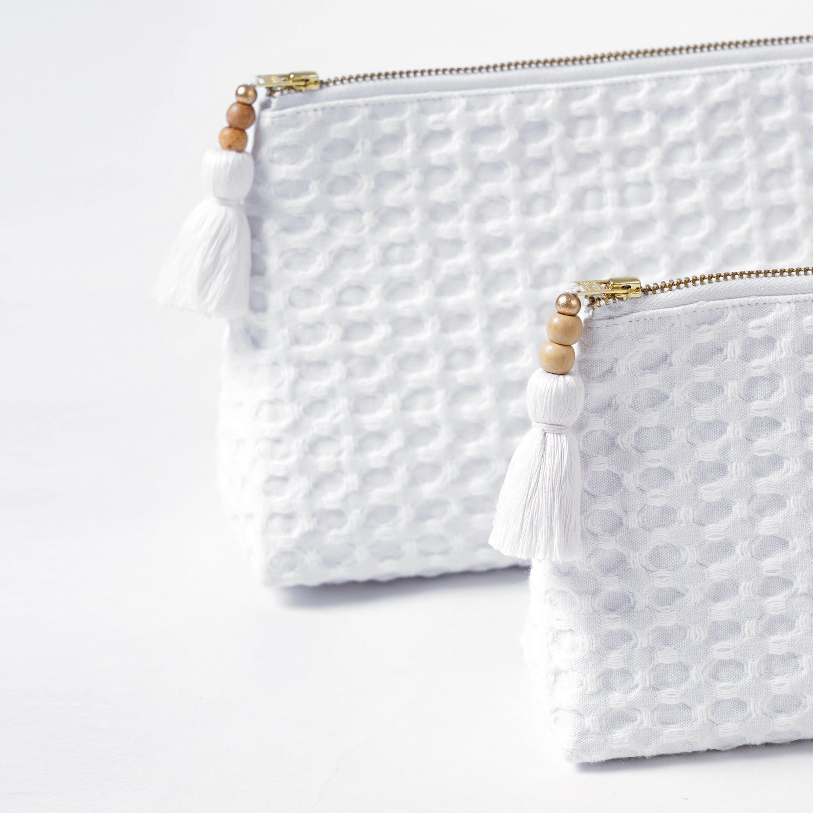 A Pair of White Waffle Nesting Pouches With Zipper Closure and Tassel ...