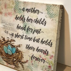Mother Sign Nest Sign a Mother Holds Her Children's Hands Nest With ...