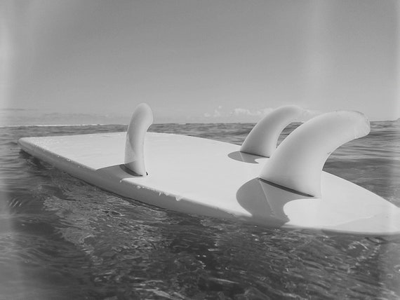 Surfboard Floating On Water