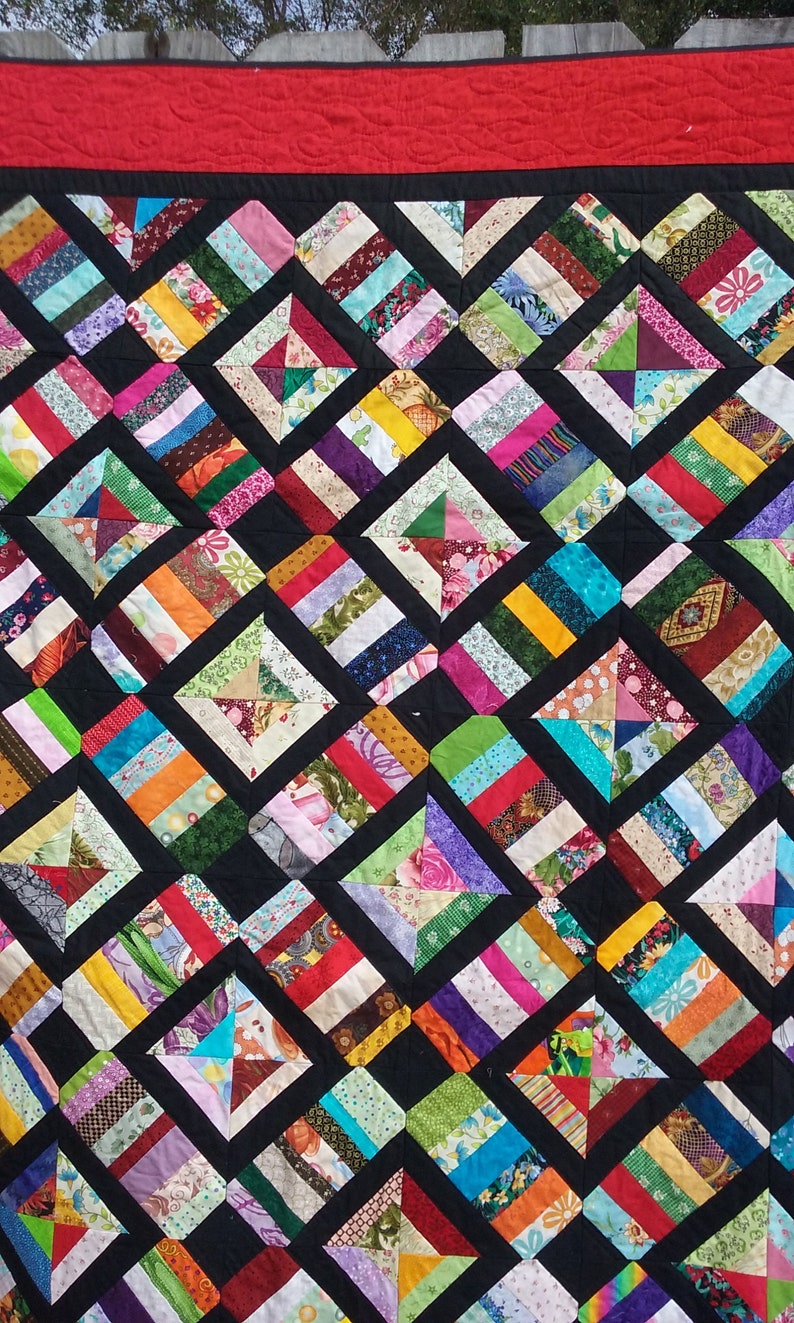 Quilt of Multicolored String Pieced Blocks With Black Stripes and Black ...