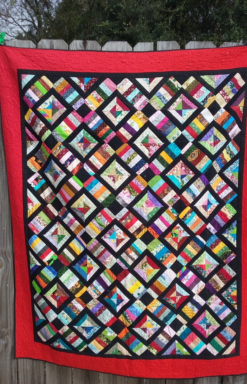 Quilt of Multicolored String Pieced Blocks With Black Stripes and Black ...