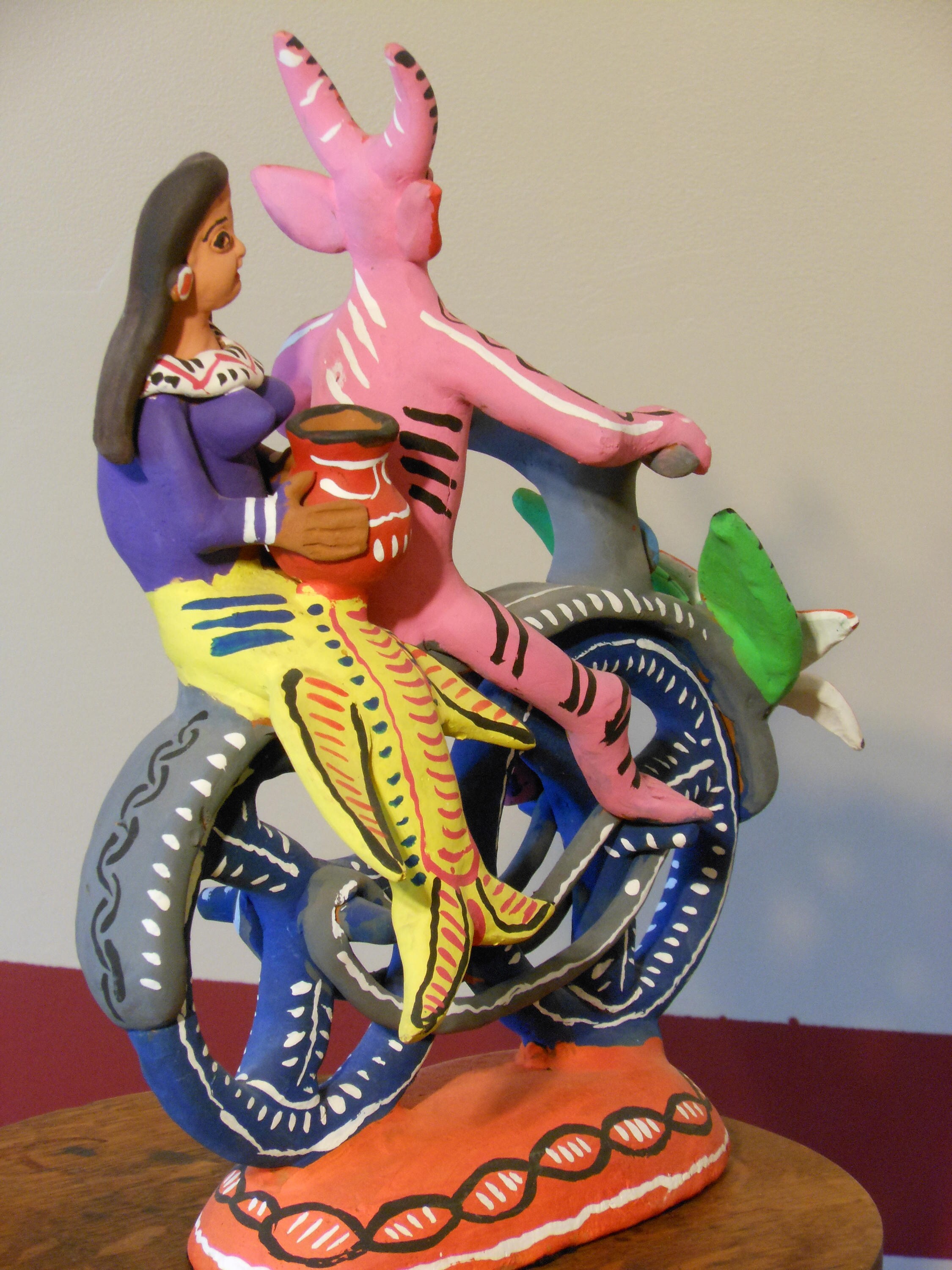 Devil and a Mermaid Riding a Bicycle