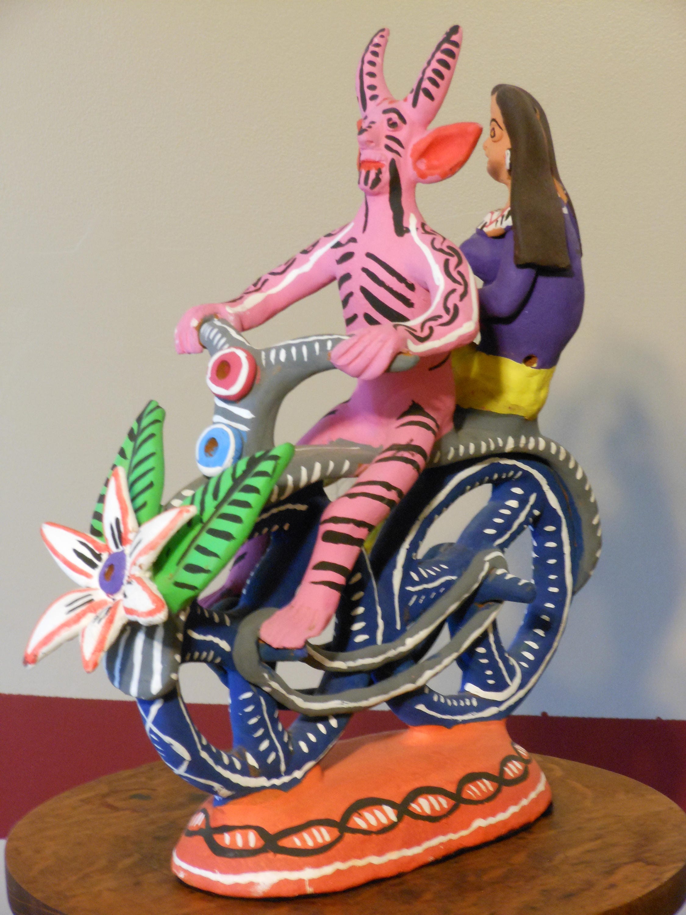 Devil and a Mermaid Riding a Bicycle