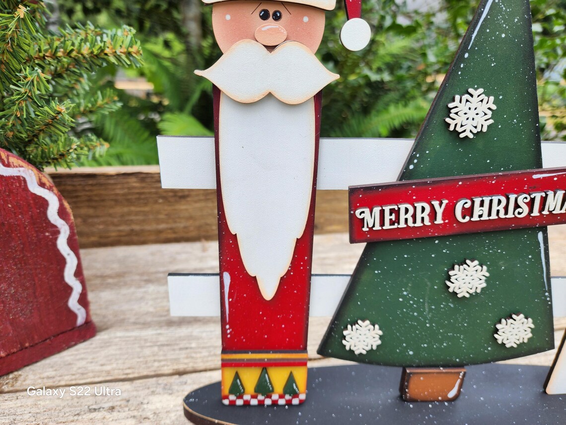 This Laser Cut File is a Christmas Trio Picket Fence Featuring a Santa ...