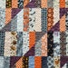 October is a Quilted Throw Made With Fabrics in a Variety of Autumnal ...