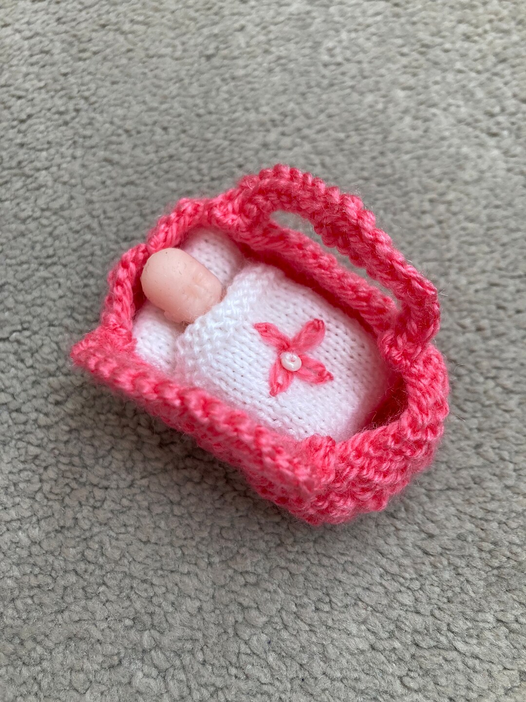 Micro Mini Silicone Baby in a Hand Knitted Carry Cot and Sleeping Bag ...
