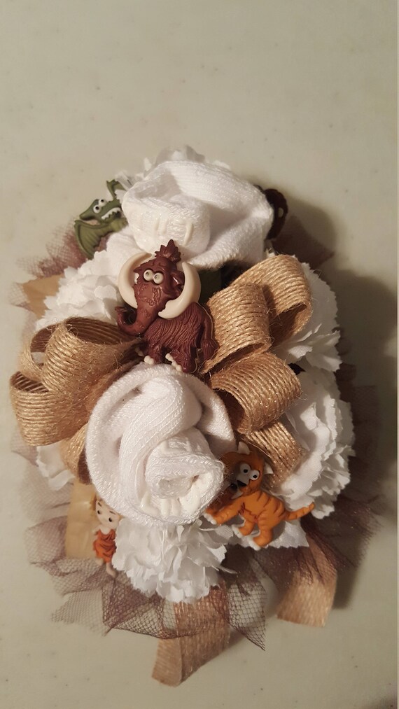 Stone Age baby sock corsage | Etsy