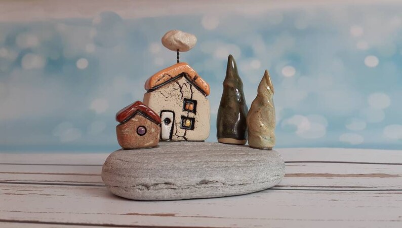 Small Sculpture Art of a Ceramic Houses and Trees on a Flat Gray Beach ...