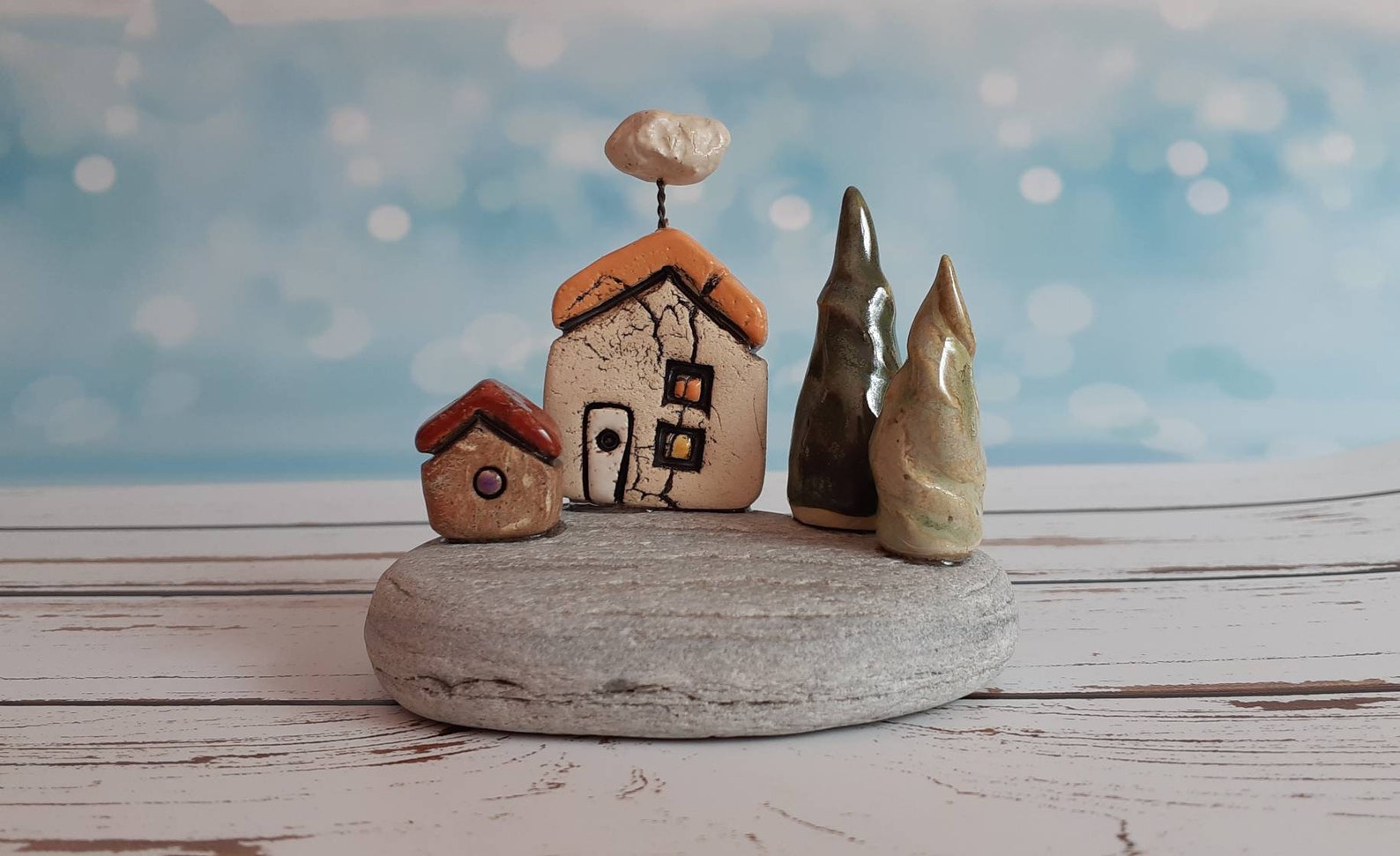 Small Sculpture Art of a Ceramic Houses and Trees on a Flat Gray Beach ...