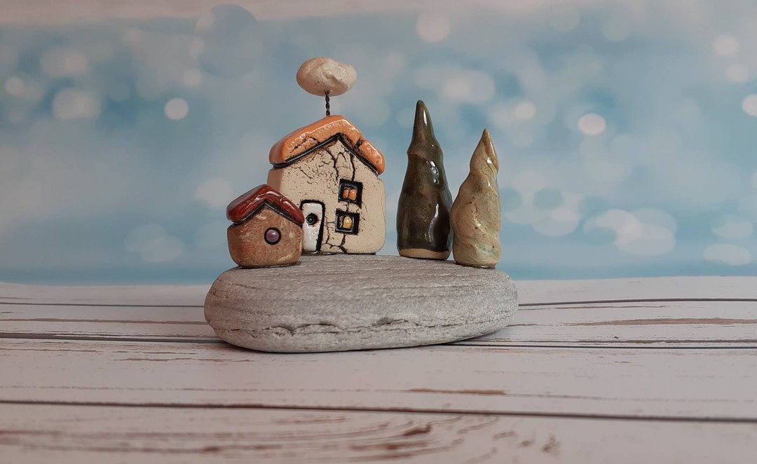 Small Sculpture Art of a Ceramic Houses and Trees on a Flat Gray Beach ...