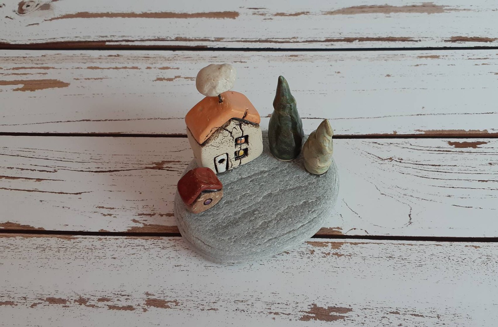 Small Sculpture Art of a Ceramic Houses and Trees on a Flat Gray Beach ...