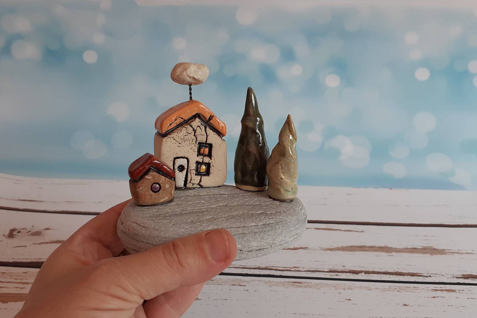 Small Sculpture Art of a Ceramic Houses and Trees on a Flat Gray Beach ...