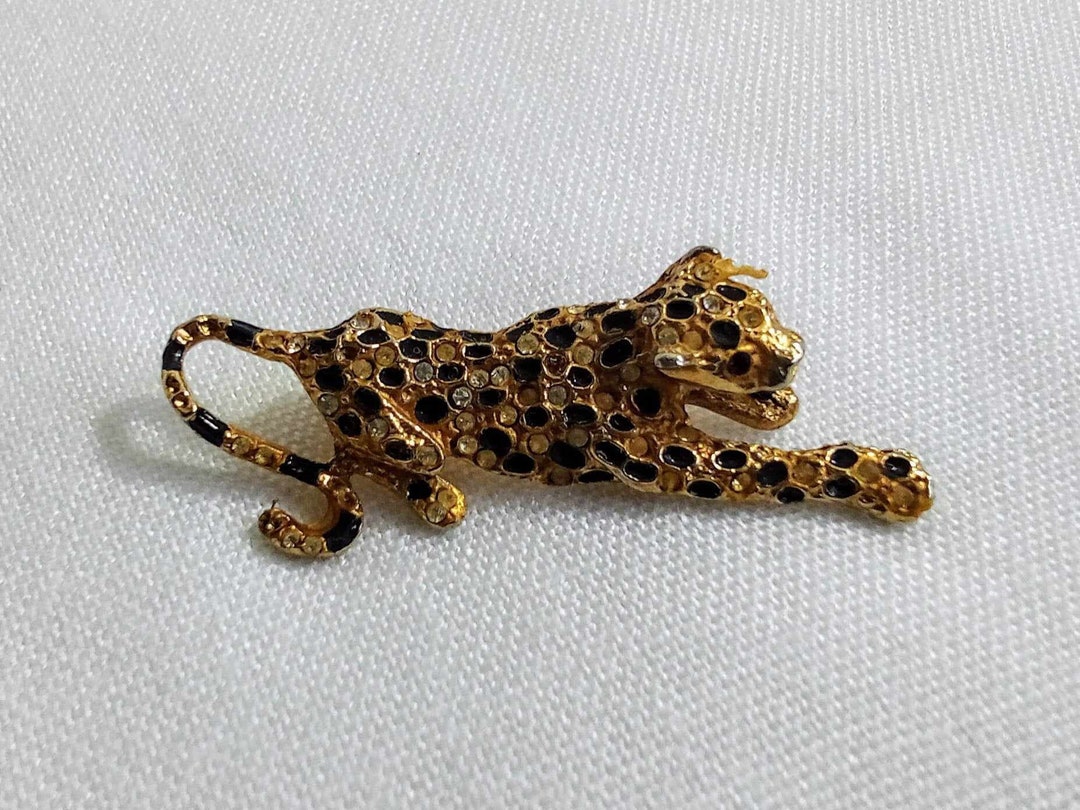 JP30. Broche léopard vintage dorée. Verre transparent et émail noir ...