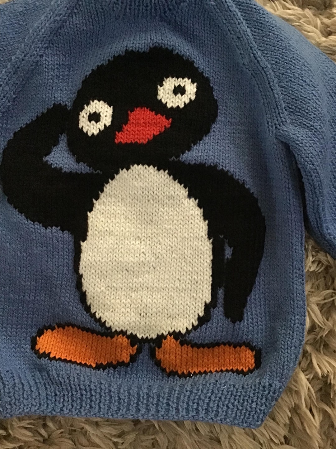 This is a Blue Sweater With Pingu Embroidered on the Front. It Fits a ...