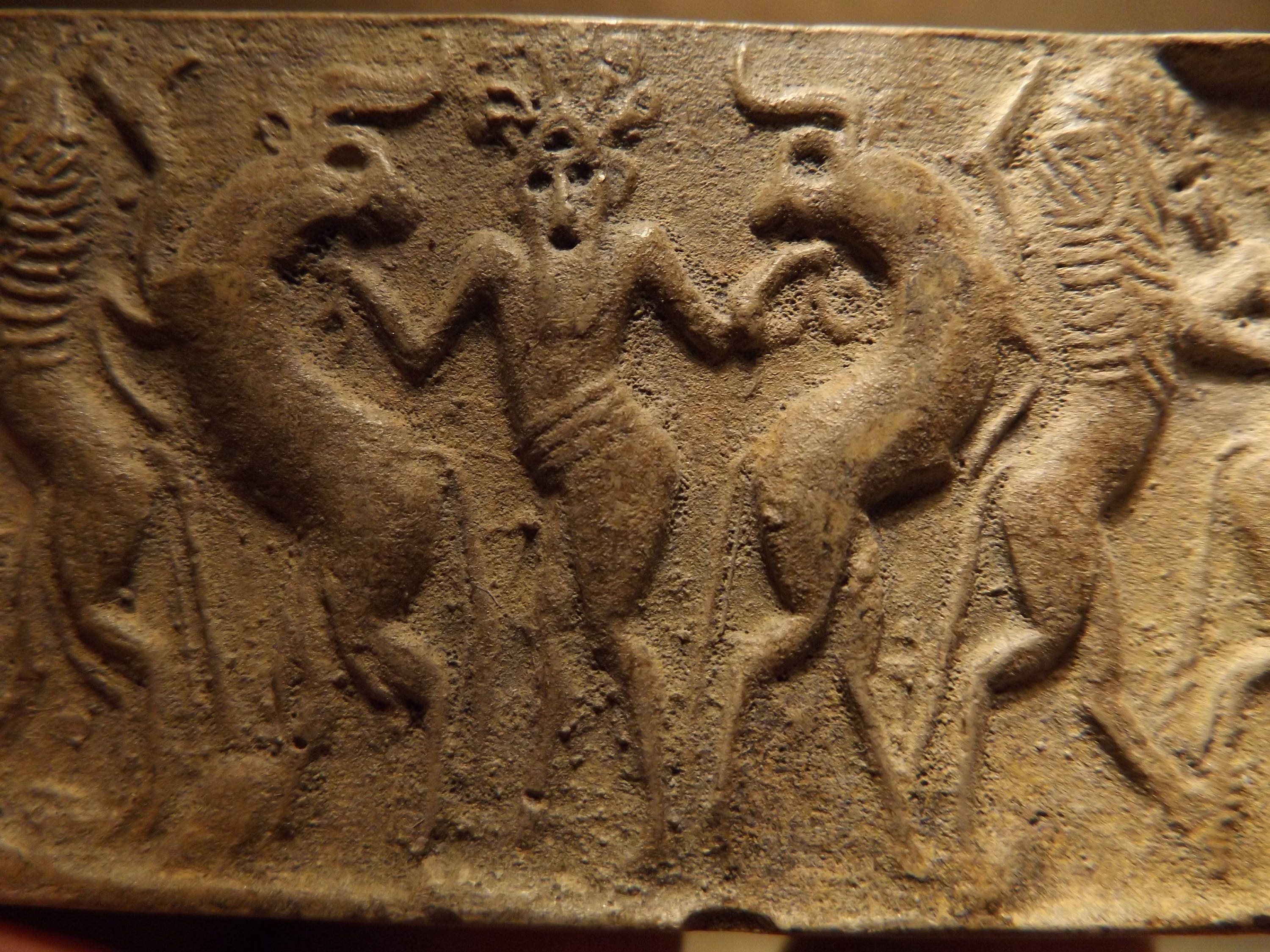 Sumerian cylinder seal impression - Master of animals. Museum replica