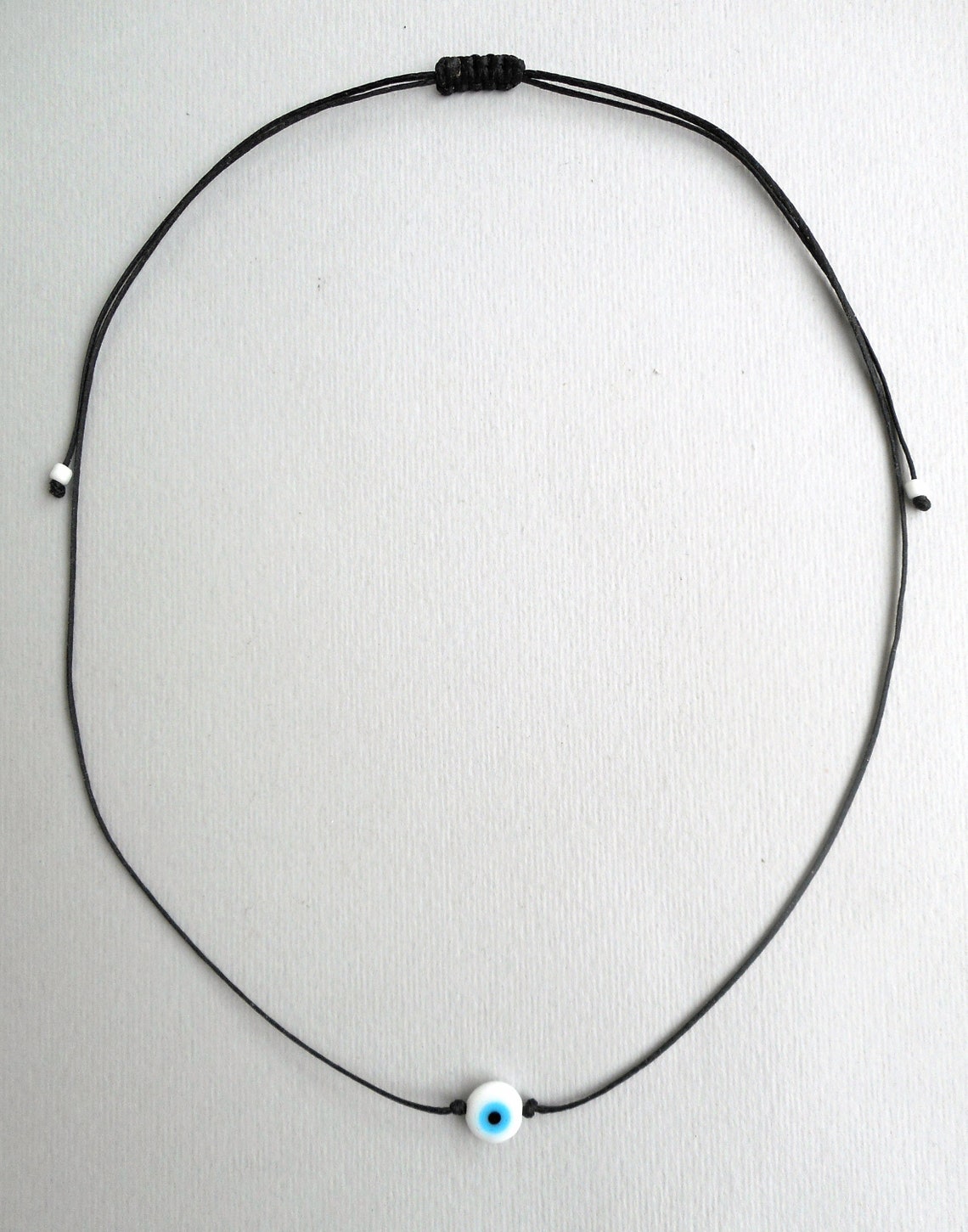 White evil eye necklace Black string choker Devils eye bead | Etsy