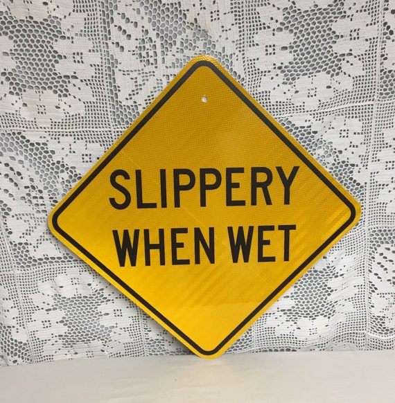 Slippery When Wet Road Sign