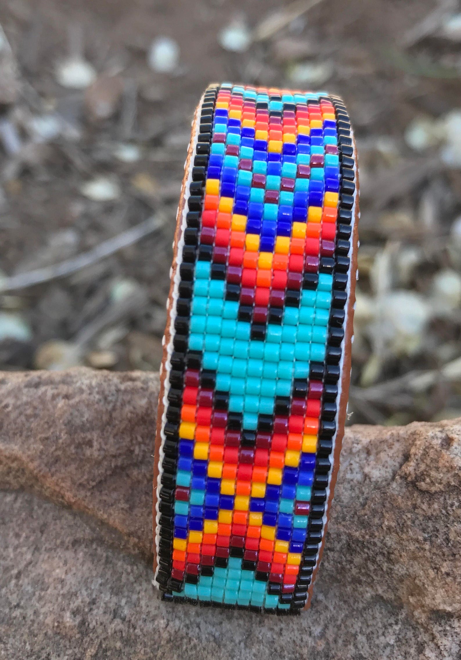 Geometric Beaded Bracelet in Reds, Orange, Yellow and Blues on a ...