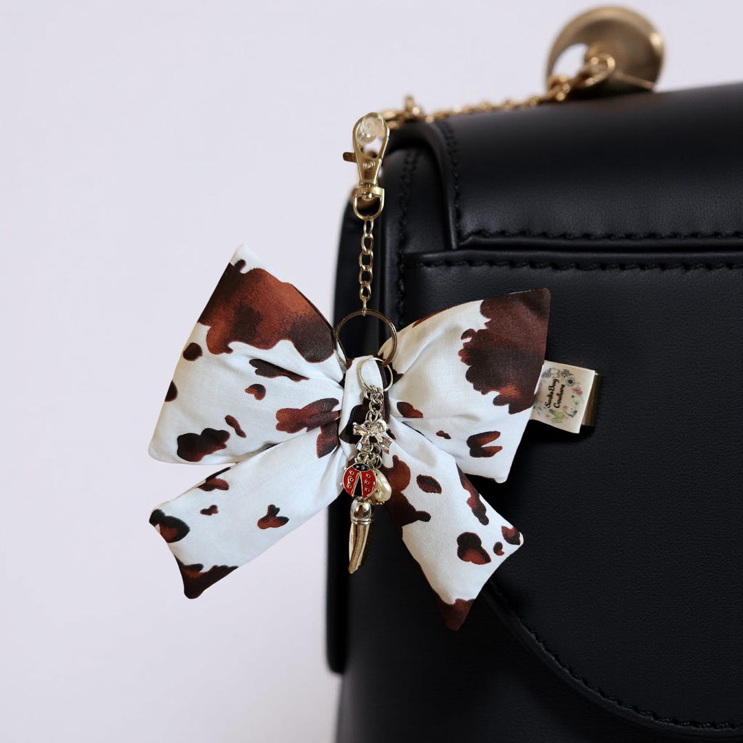 Empowering Cow Print Bow Keychain With Ladybug & Pearl Charms ...