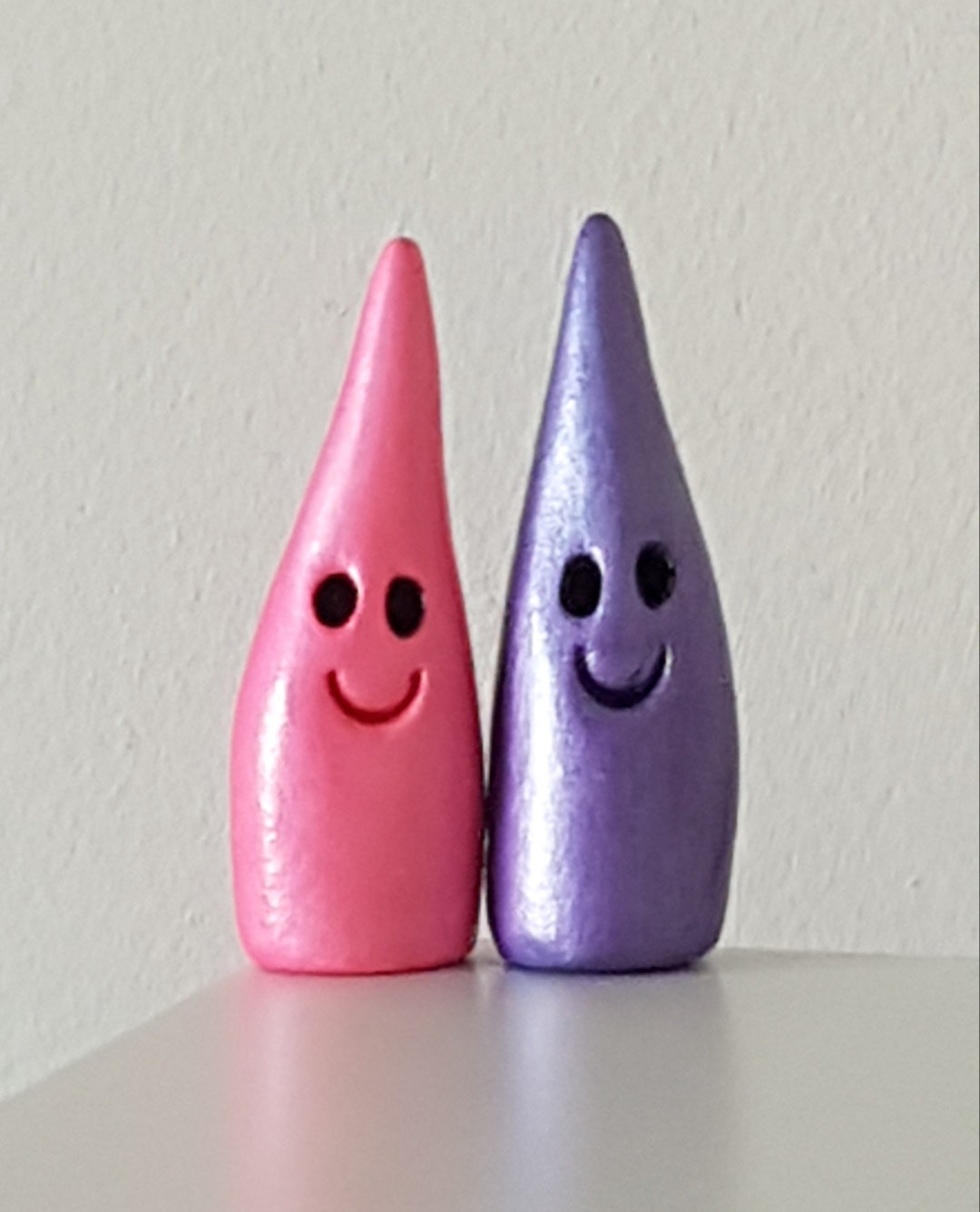 Pair of Smiling Figurines Pink and Purple Whimsical Minimalistic Style ...