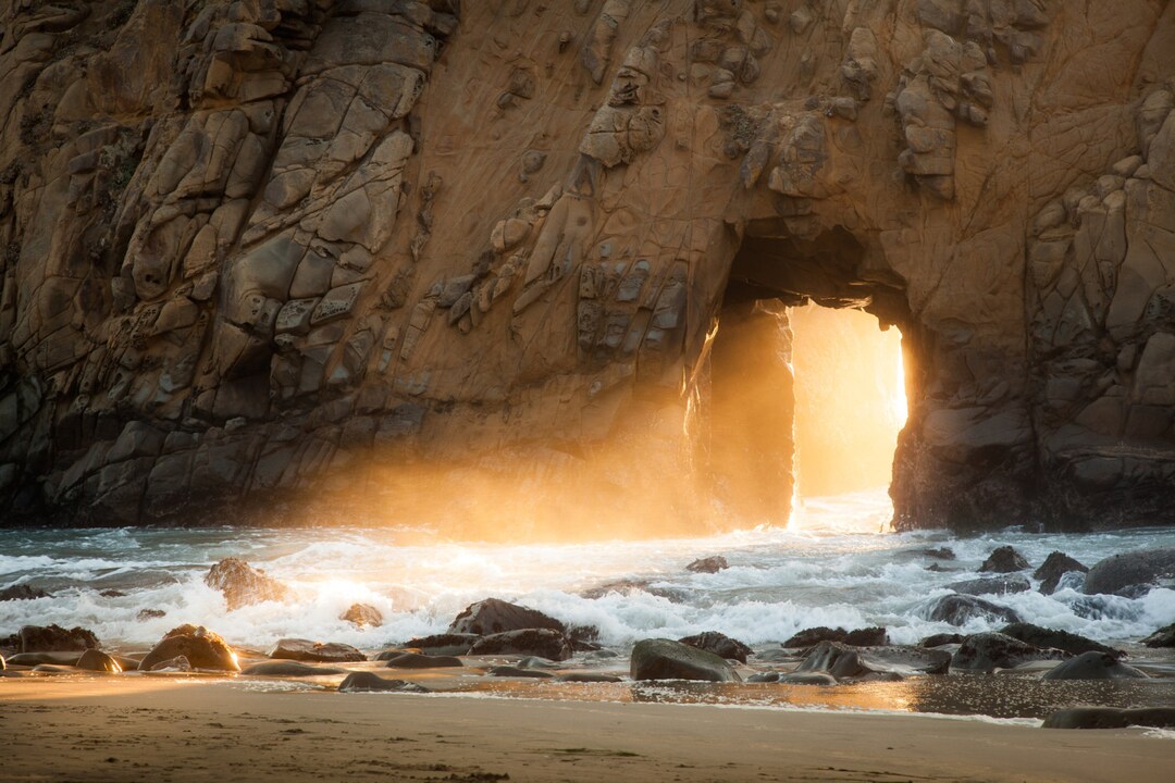 Beautiful Light Shining Through Rock Keyhole Beach Landscape Photo ...