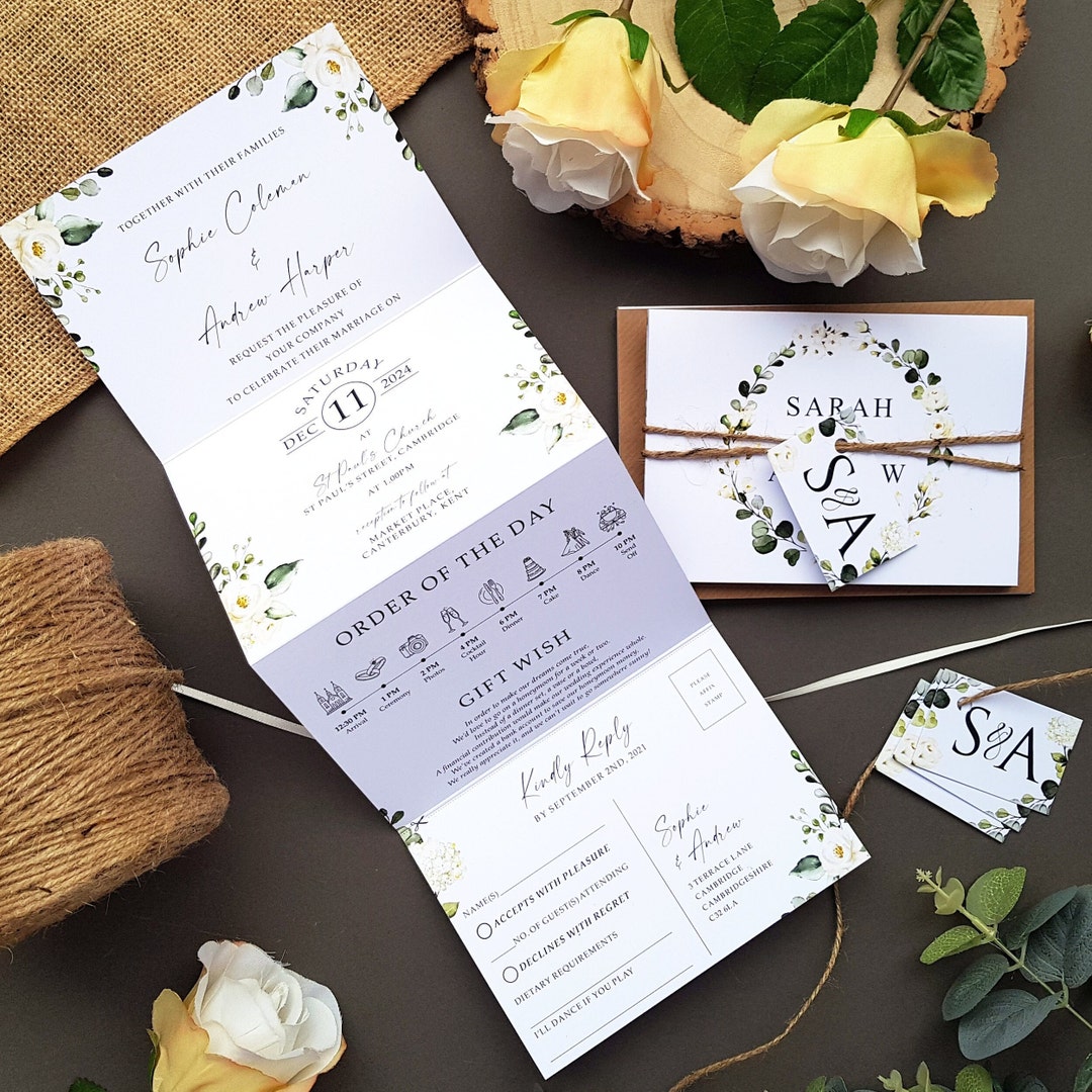 Wedding Invitation Set Featuring an Array of White Florals and Greenery ...