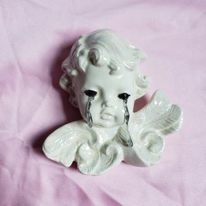 Cherub Angel Baby Face Crying Black Eyes Iridescent Porcelain Ornament ...