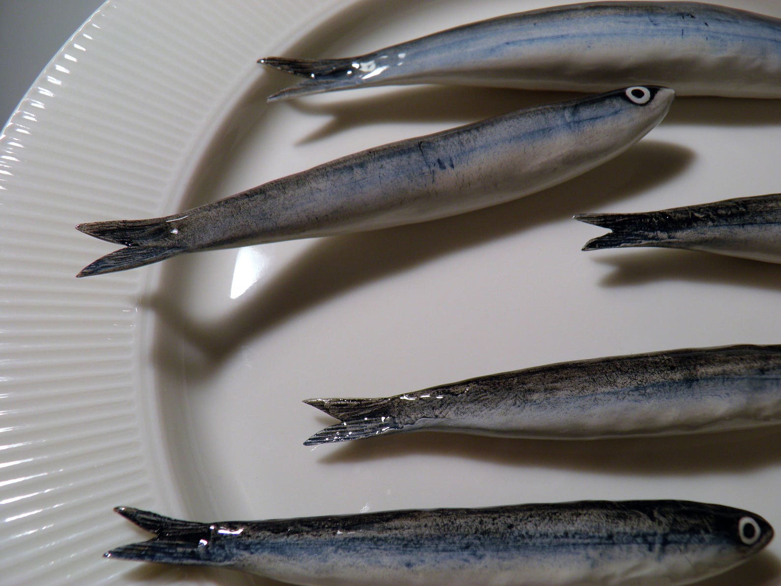 Hand-shaped and Hand-decorated Ceramic Anchovies on a Porcelain Plate ...