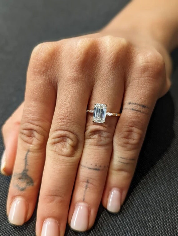 2 carat emerald cut diamond ring on finger store