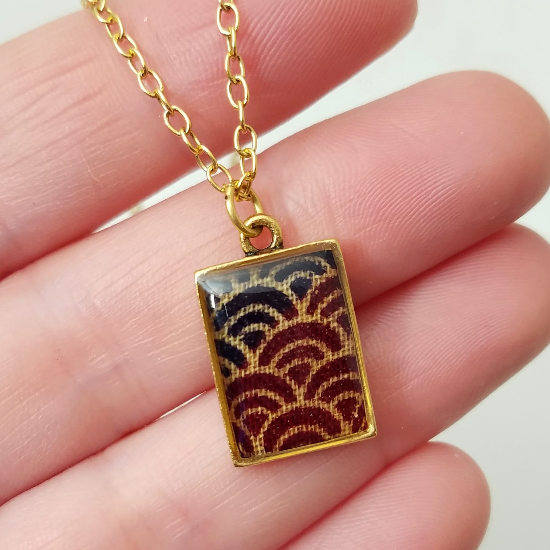 24k gold rectangle pendant necklace with deep maroon and blue wave ...