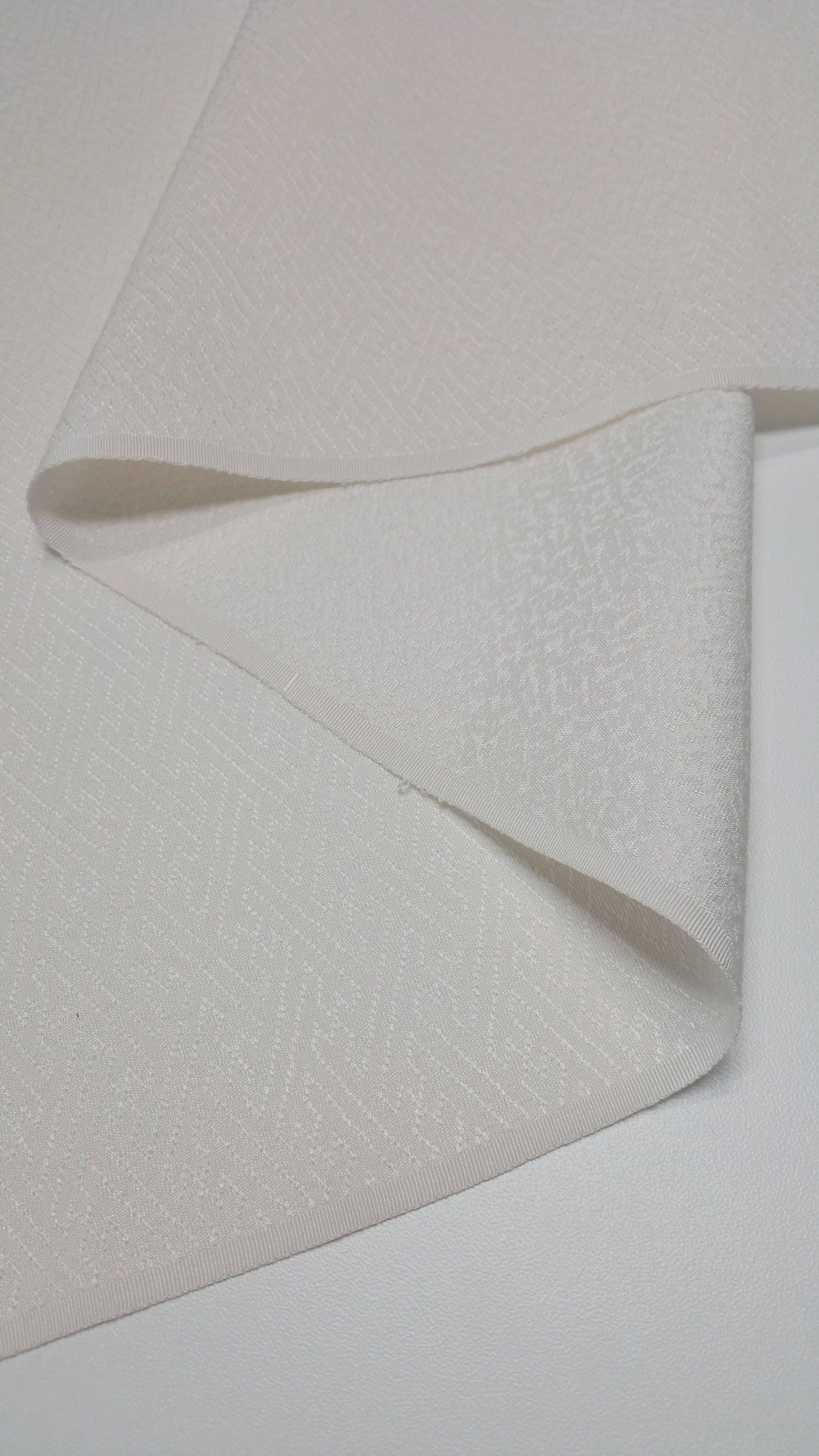 Off-white colored silk rinzu damask kimono fabric with woven sayagata ...