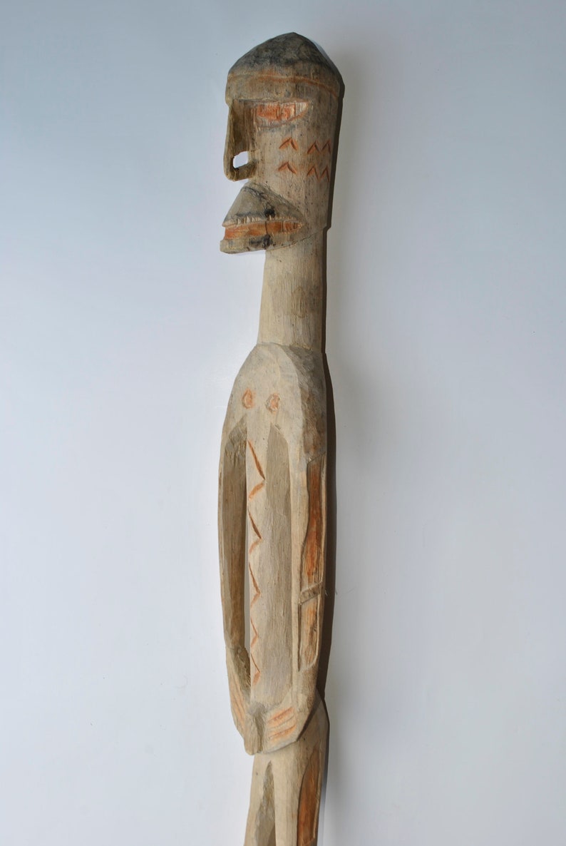 Tall Sculpture of Asmat Male Figure Standing on Head of Hornbill a ...