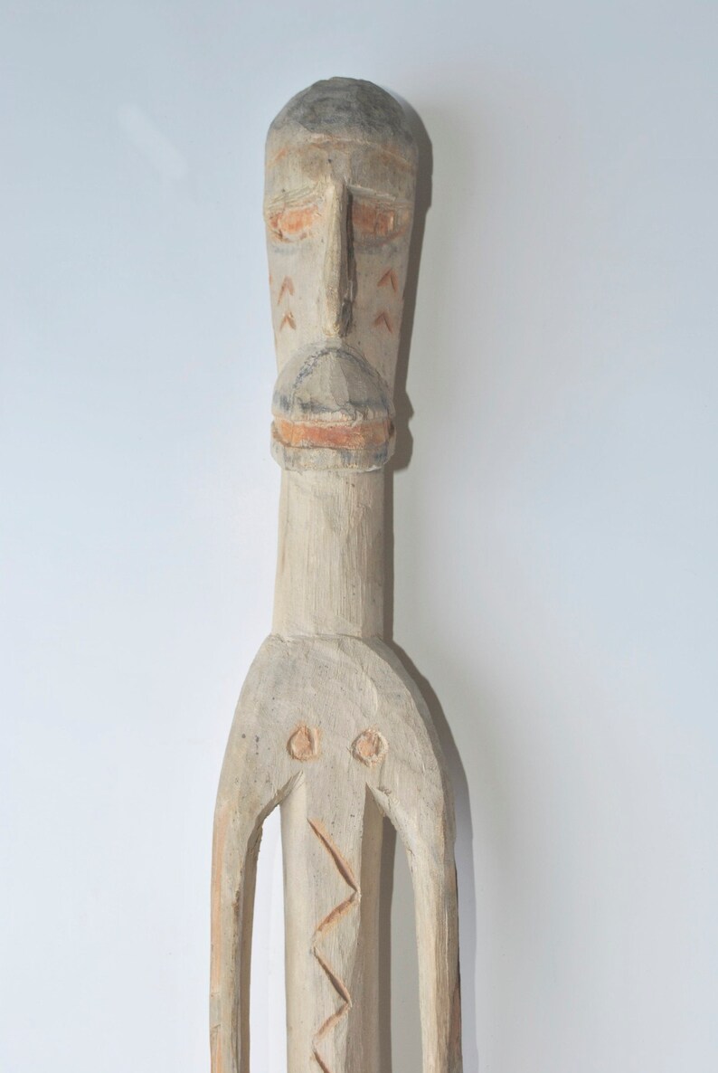 Tall Sculpture of Asmat Male Figure Standing on Head of Hornbill a ...