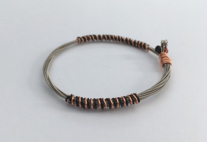 Recycled Guitar String Bracelet styled with black and bronze | Etsy