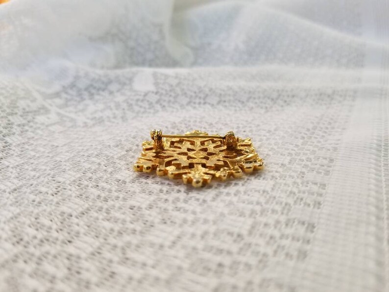 Gold tone metal snowflake brooch with faux silver rhinestones | Etsy