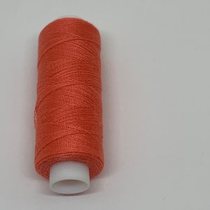 Red Thread. Sew All Polyester Thread Spool. Red 100% Polyester Thread ...