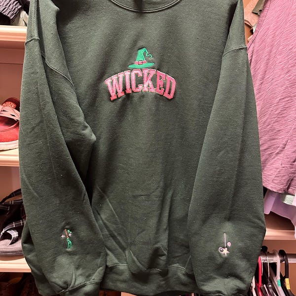 Wicked Defy Gravity Embroidered Sweatshirt, Witch Pink and Green ...
