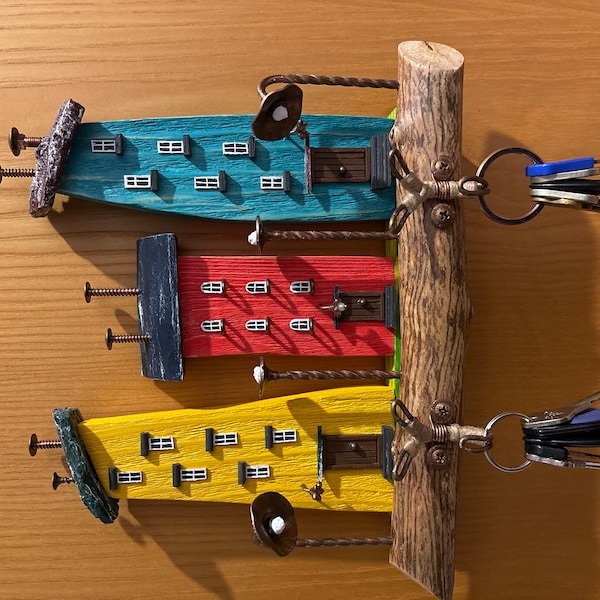 Wooden Key Holder With Colorful Houses and Green Plants on a Wild ...