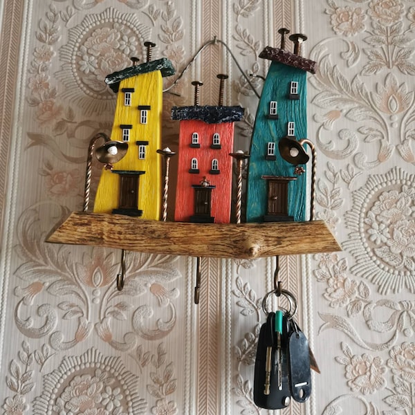 Wooden Key Holder With Colorful Houses and Green Plants on a Wild ...
