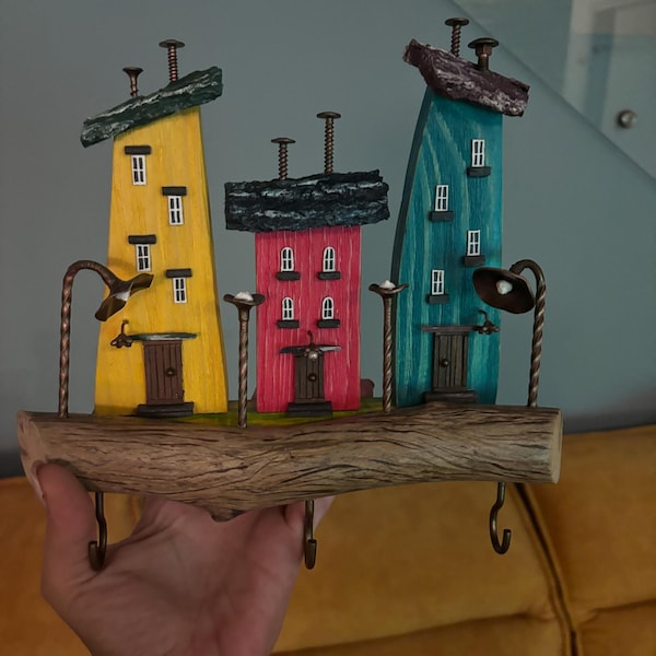 Wooden Key Holder With Colorful Houses and Green Plants on a Wild ...