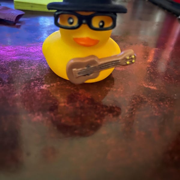 A Rubber Duck Playing a Musical Instrument of Your Choice, Adorned With ...