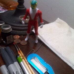 Batcave Trophy Room With Robin Memorial, Giant Penny, Penguin, and ...