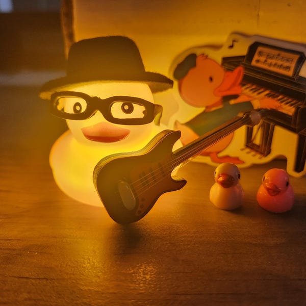 A Rubber Duck Playing a Musical Instrument of Your Choice, Adorned With ...
